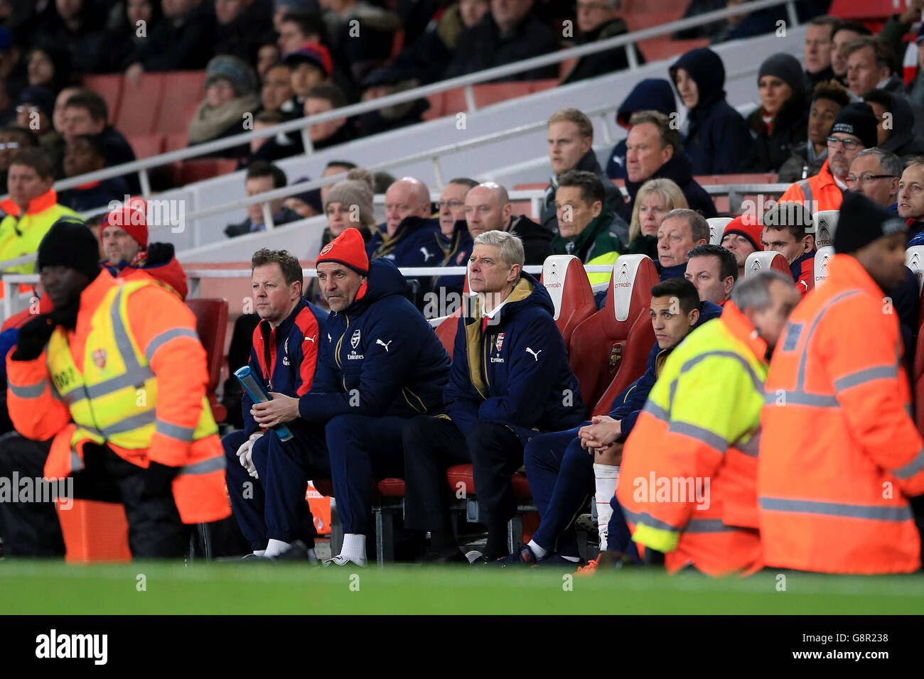 Arsenal manager Arsene Wenger (centre) with match day stewards either ...