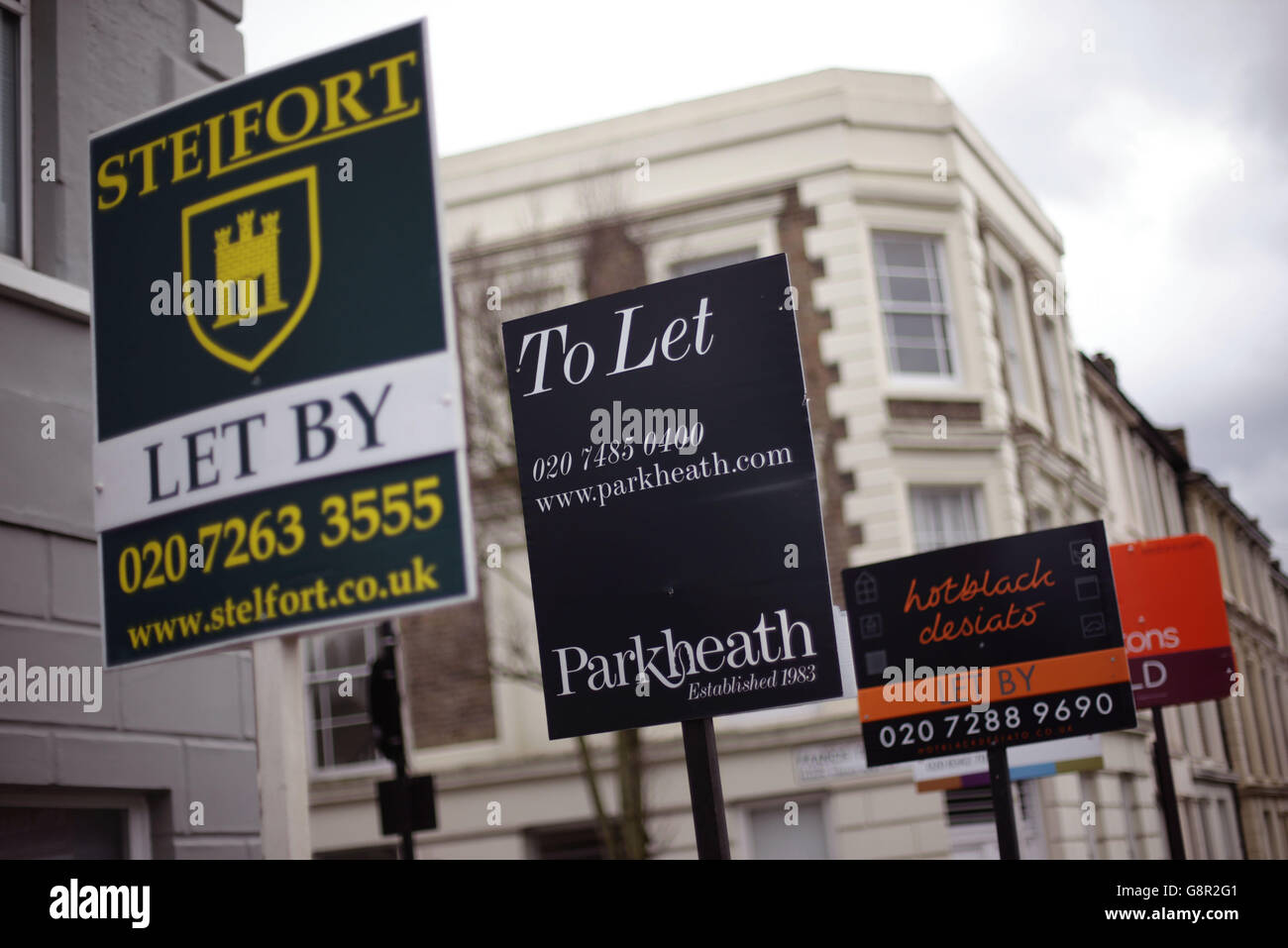 A row of Sold, To Let and Let By estate agent signs outside houses in ...