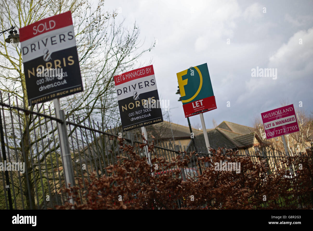 A row of Sold and Let and Managed By estate agent signs outside houses ...