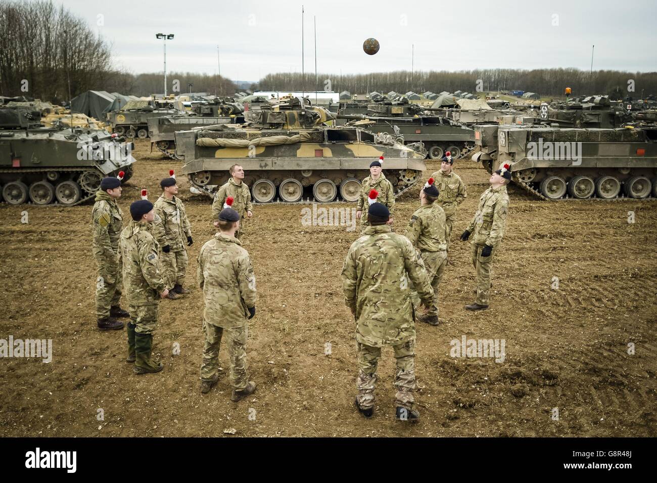 Soldiers from the 1st Battalion First Fusiliers kick a football around ...