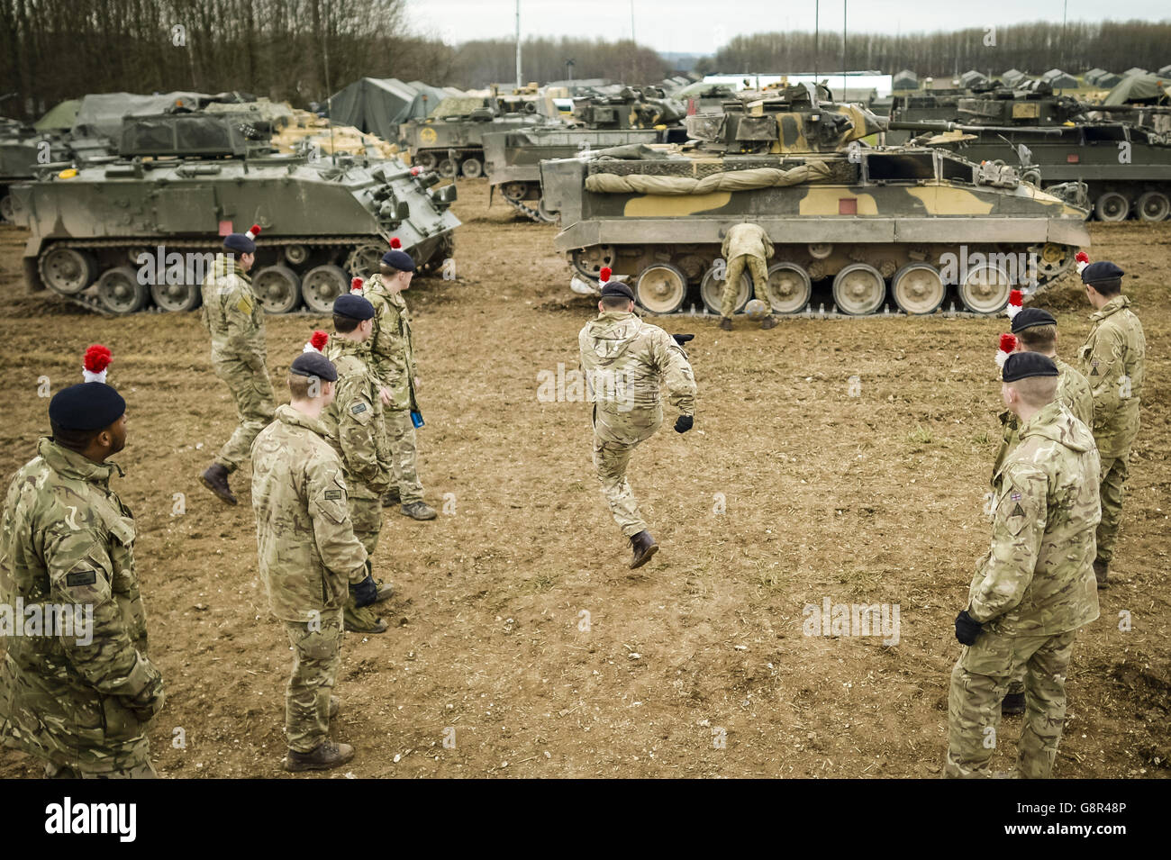 Soldiers from the 1st Battalion First Fusiliers kick a football around ...