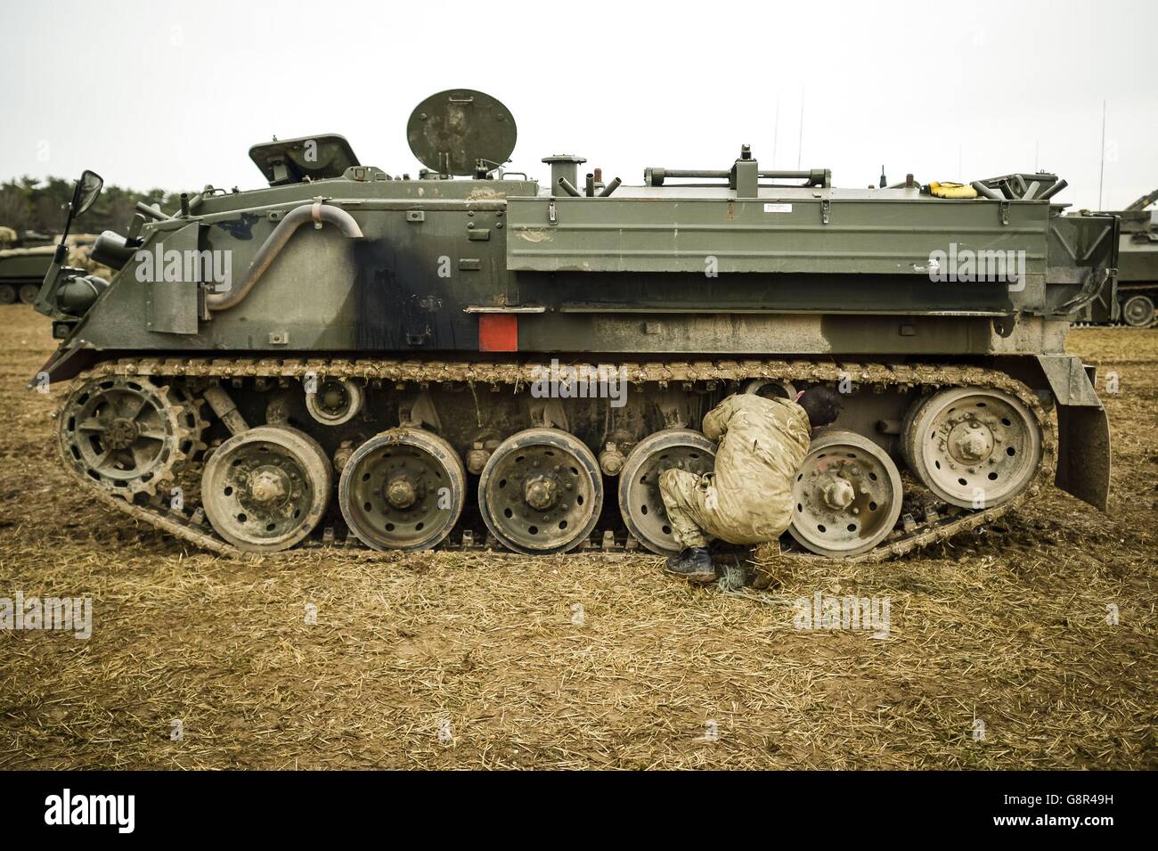 Soldiers complete routine maintenance on tanks and tracked vehicles as ...