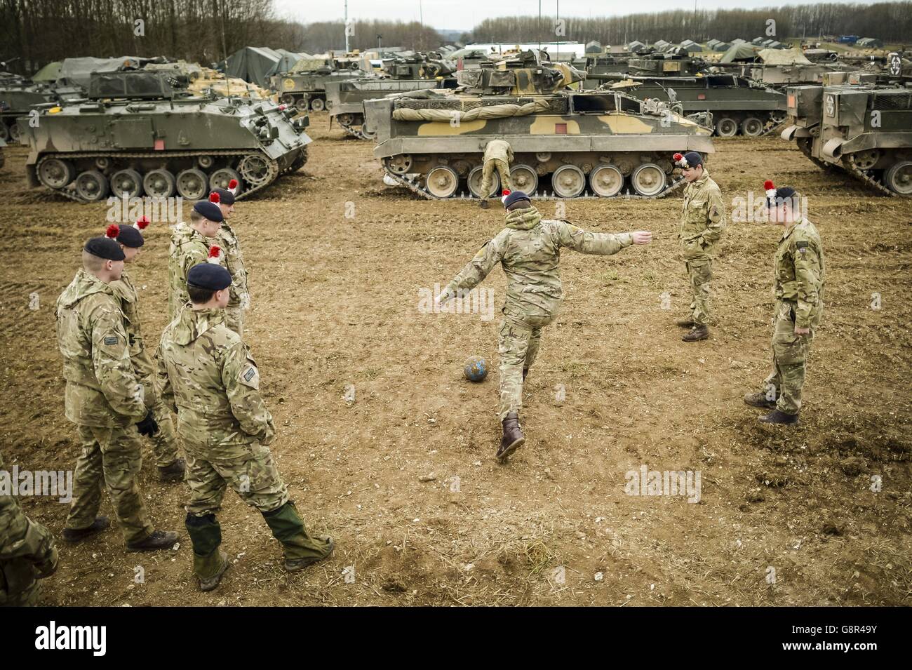 Soldiers from the 1st Battalion First Fusiliers kick a football around ...