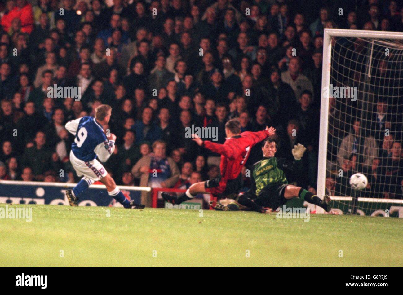 Alex Mathie (left) scores for Ipswich Town as Phil Neville (centre) and ...