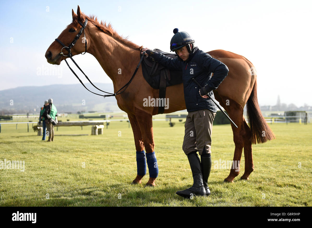 Jockey Ruby Walsh talks on his mobile phone which is lodged into his ...