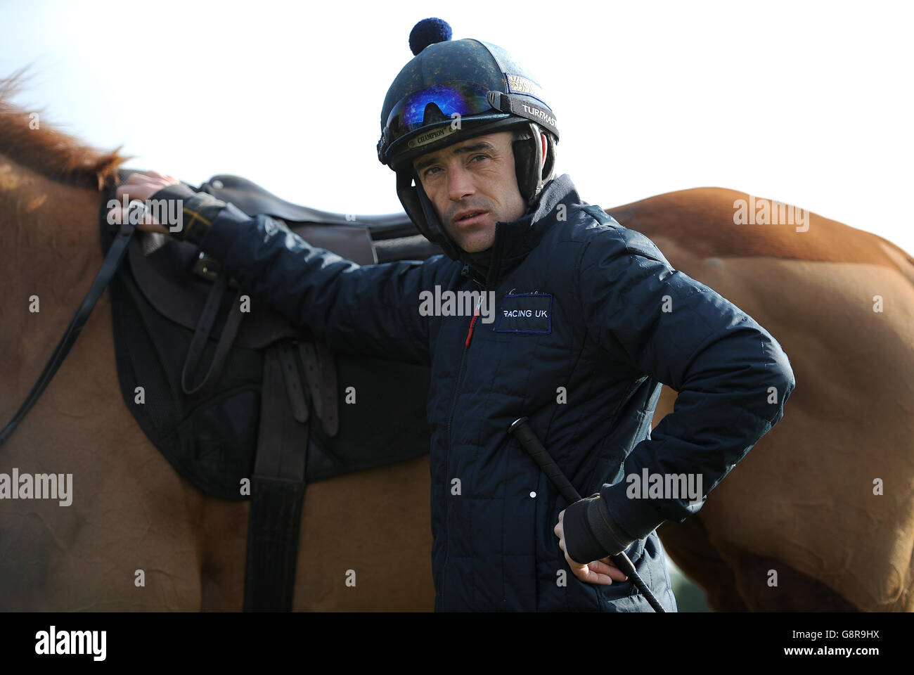 Jockey Ruby Walsh talks on his mobile phone which is lodged into his ...