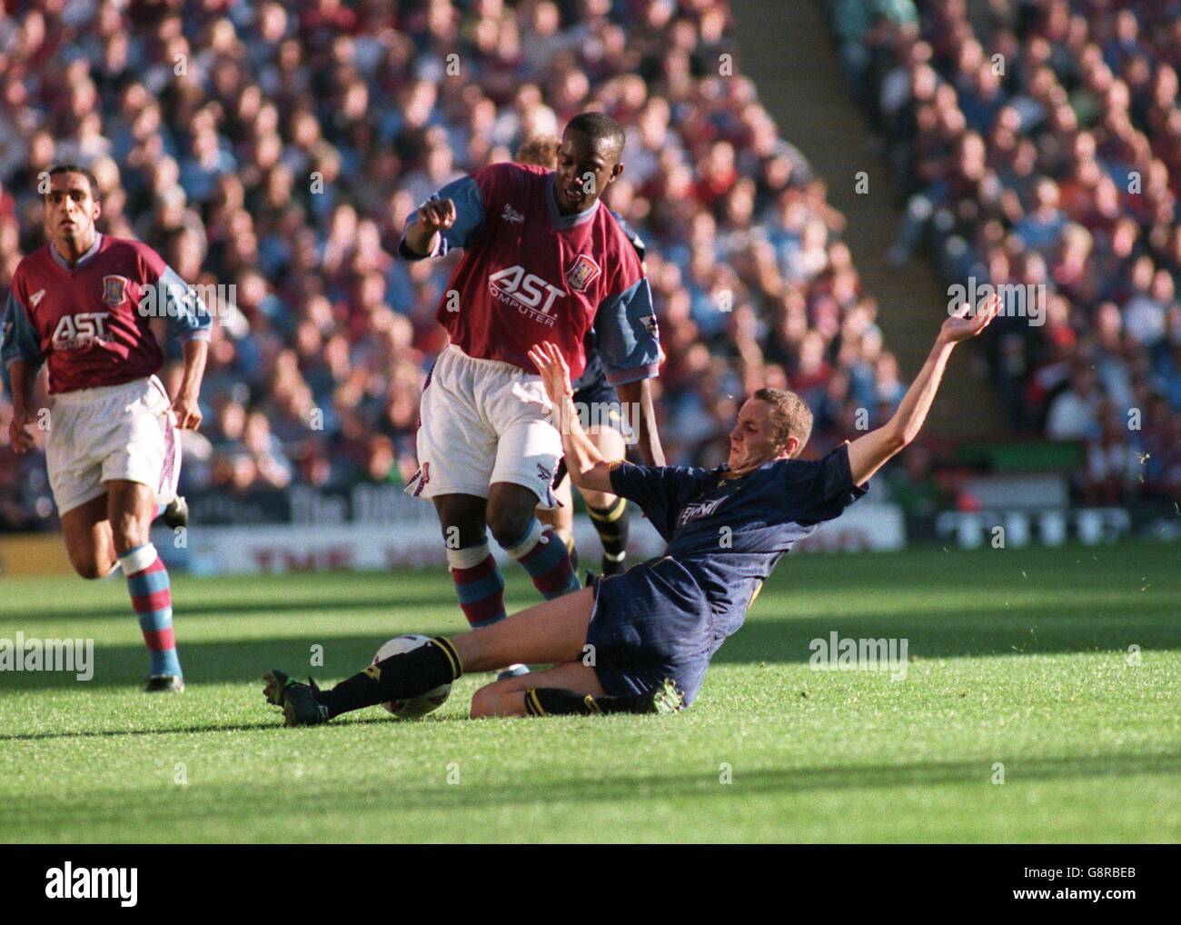 Wimbledon's Dean Blackwell (right) slides in to tackle Aston Villa's ...