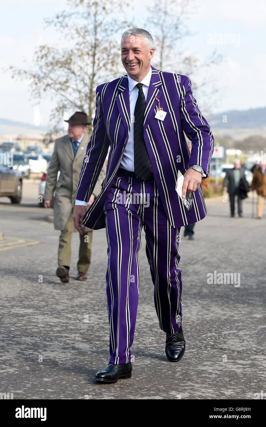 A racegoer wearing a purple suit arriving for Ladies Day of the 2016 ...