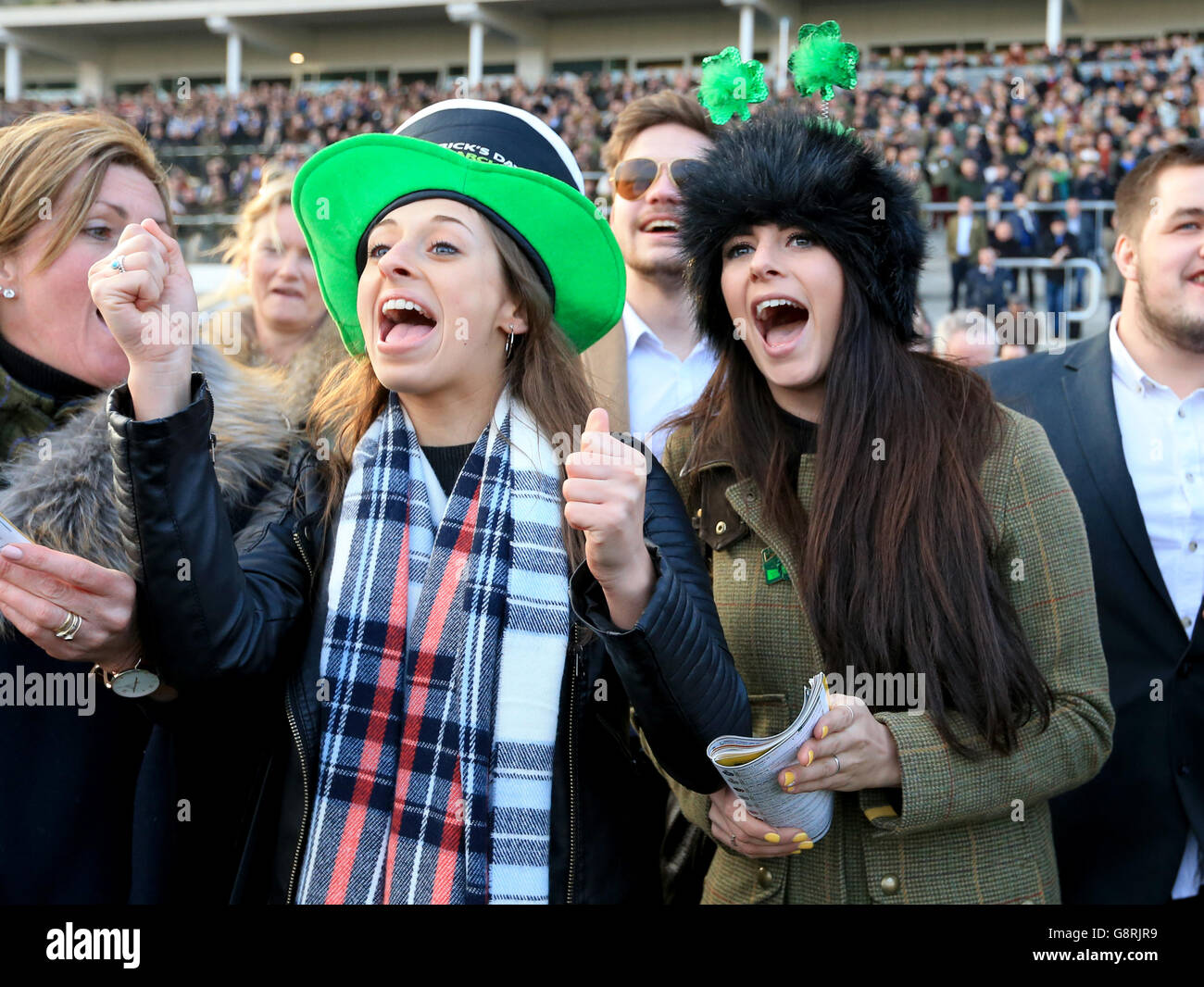 Female racegoers cheer on the horses during the Trull House Stud Mares ...