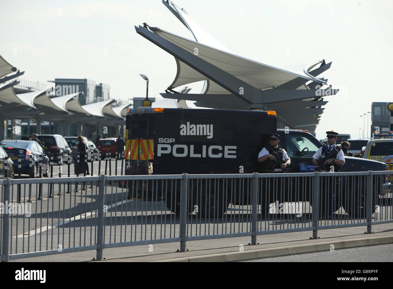 Armed police officers patrol outside Terminal 5 at Heathrow airport in ...