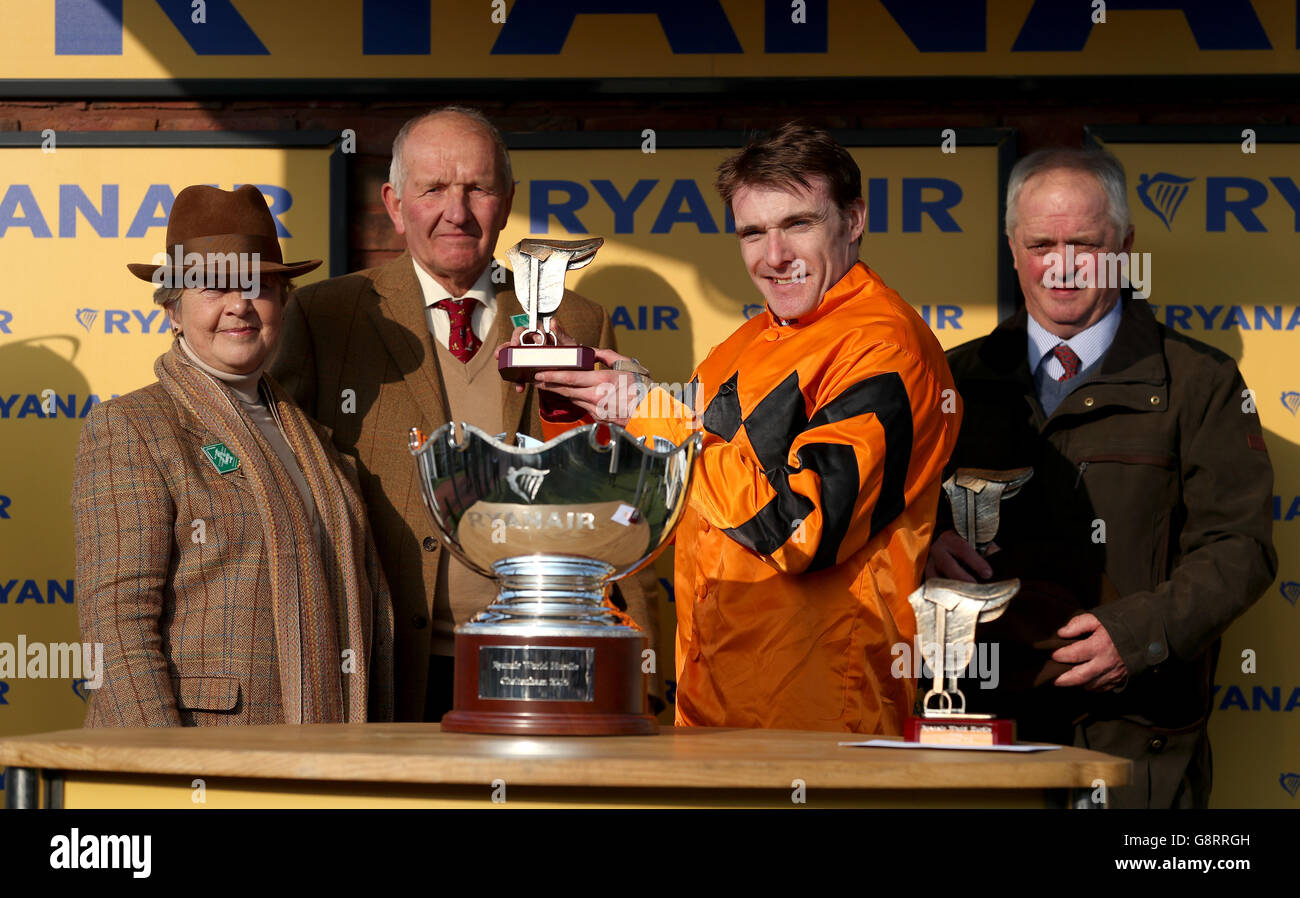 Jockey Tom Scudamore celebrates with the trophy after winning the ...
