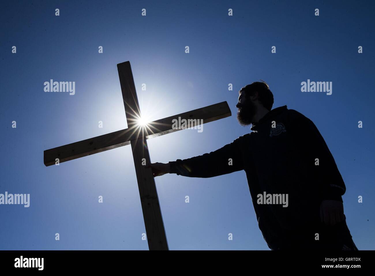 A pilgrim with a cross on the final leg of the Northern Cross ...