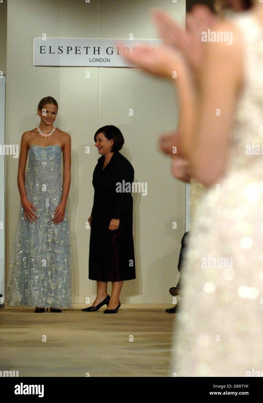 A model wears a creation by designer Elspeth Gibson (right), during her ...