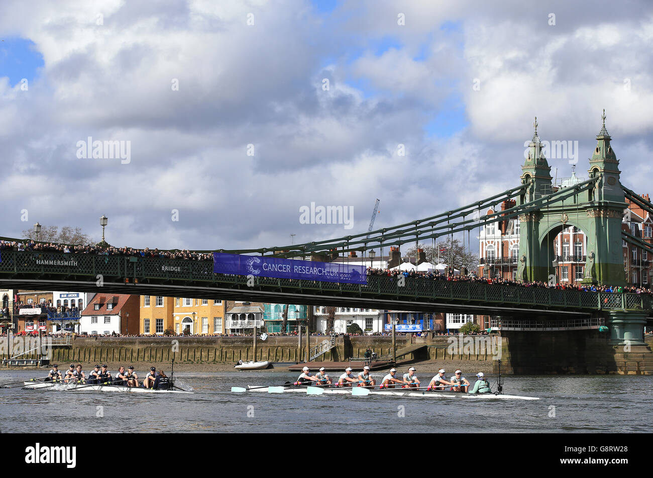 Team Oxford (left) lead Team Cambridge under Hammersmith Bridge during ...