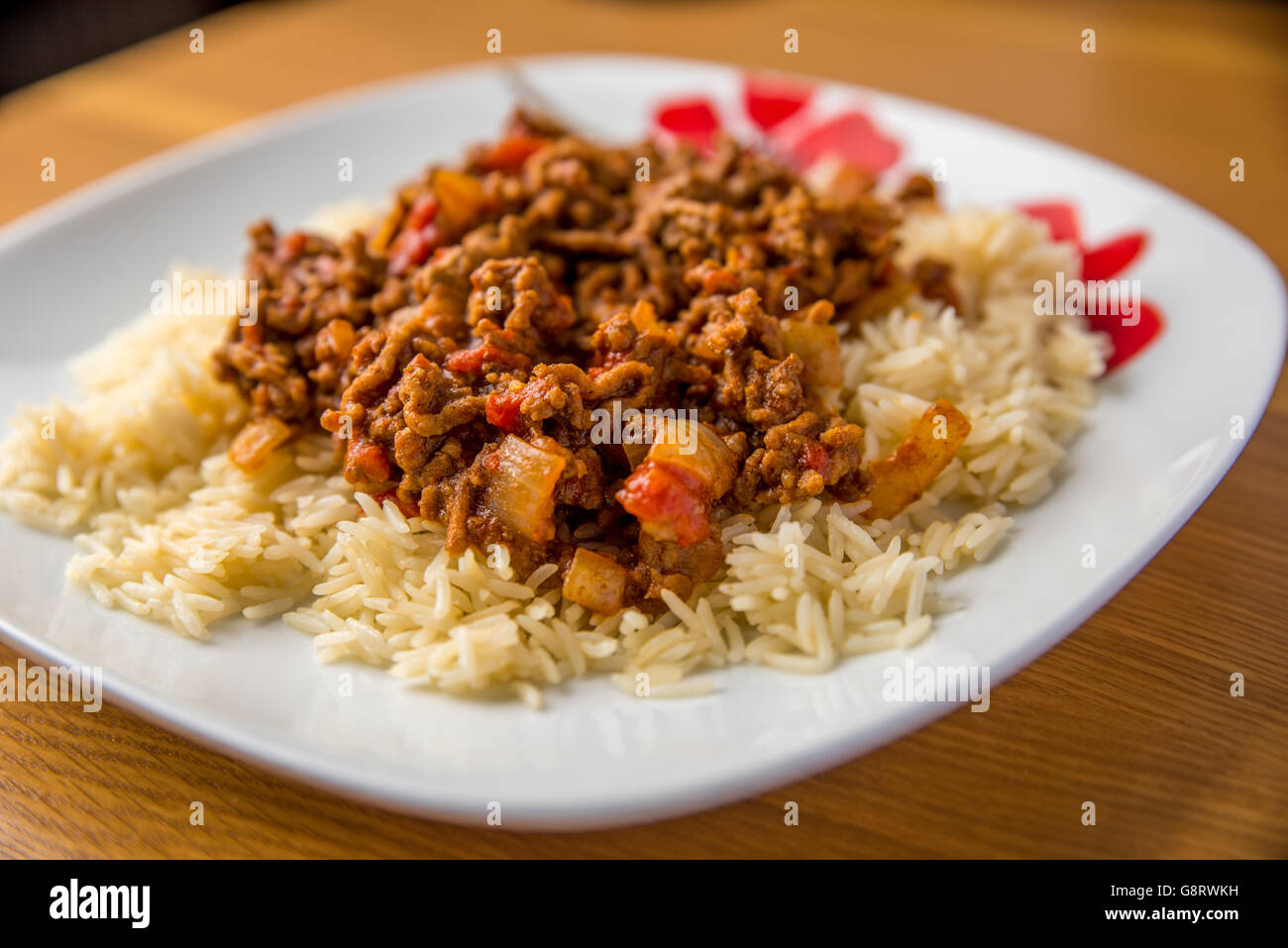 A plate of chilli con carne on a dinner table Stock Photo - Alamy
