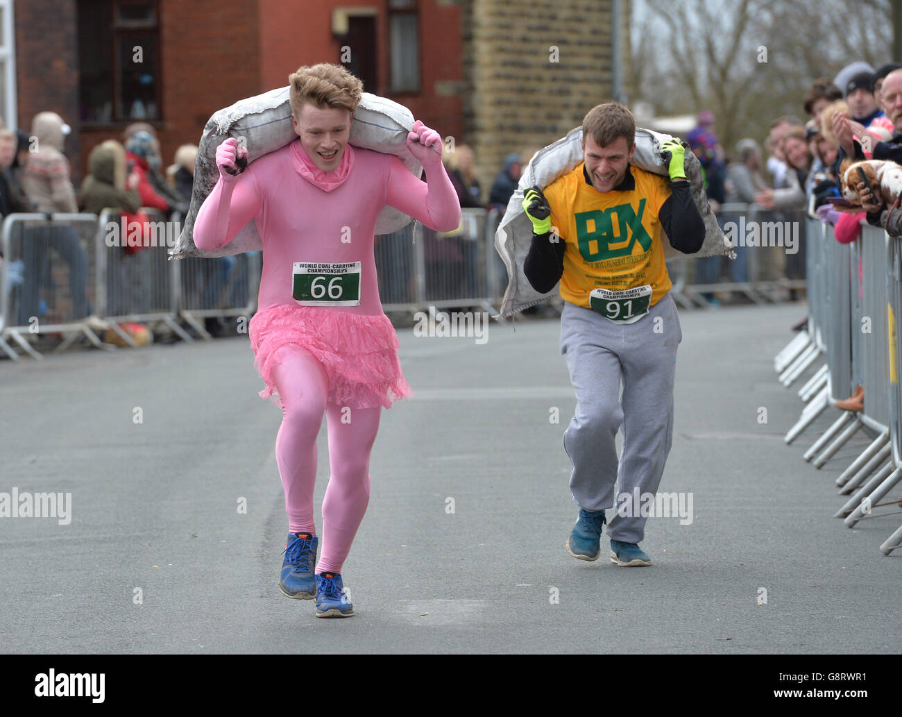 Two competitors race to the finish line during the World Coal Carrying ...