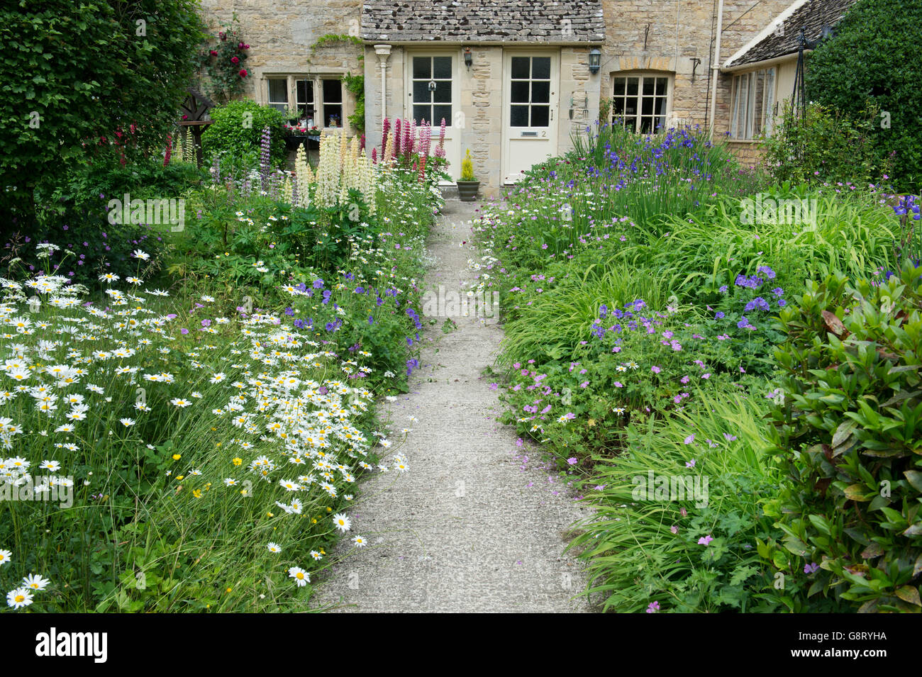 Cottage and garden in spring. Upper Slaughter, Cotswolds ...