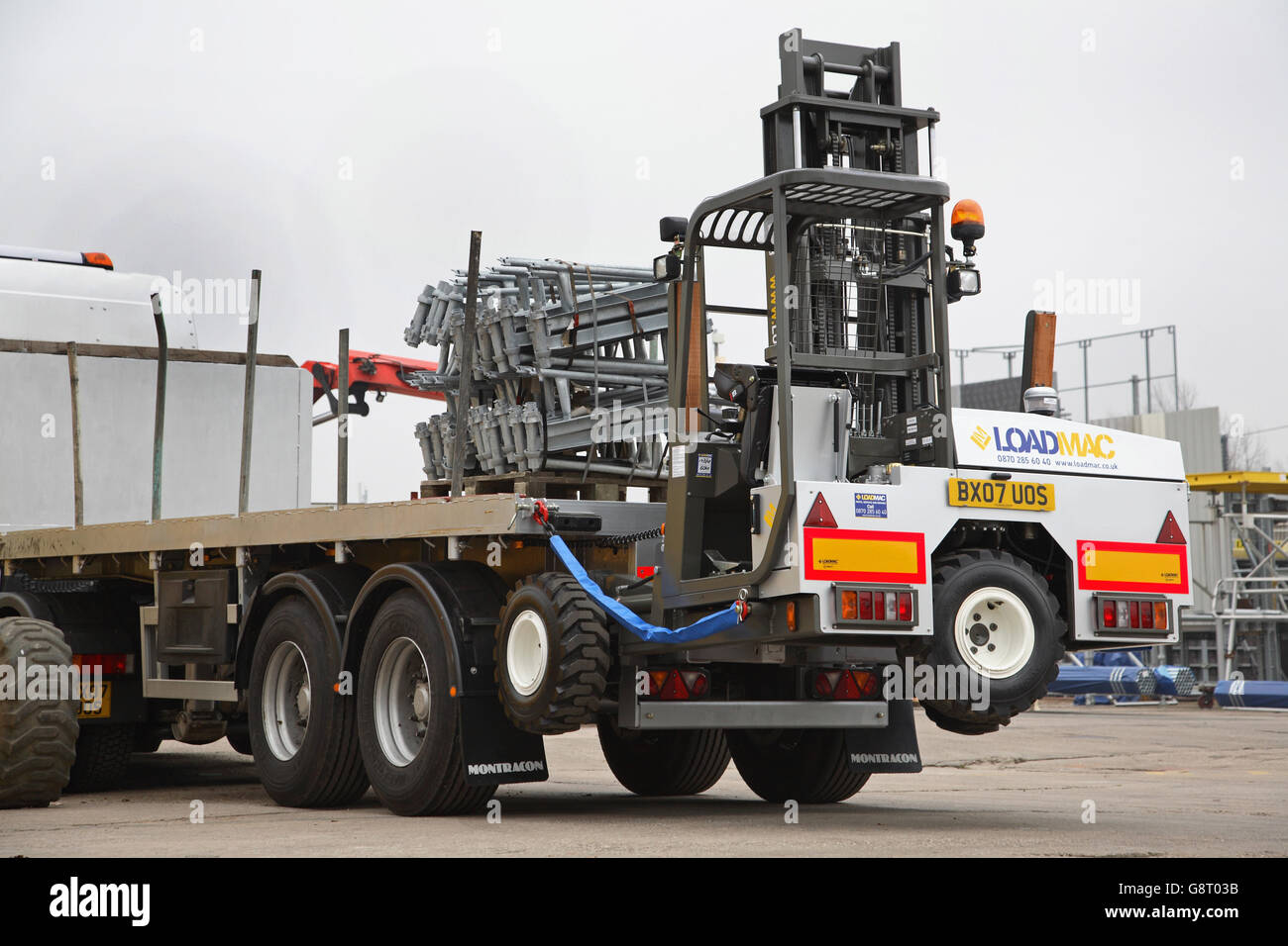 A truck-mounted fork lift truck in it's transport position attached to ...