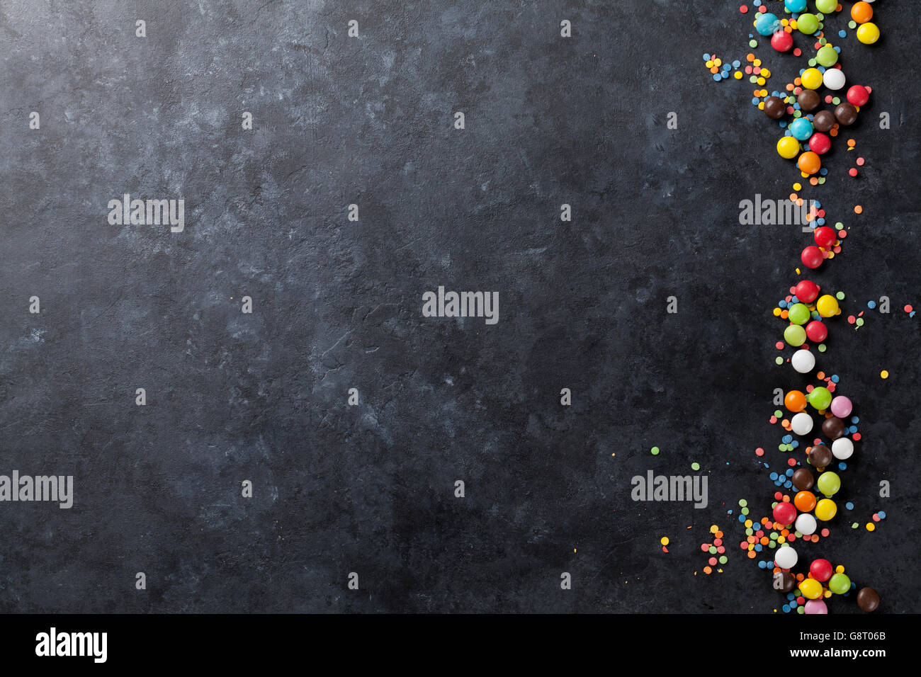 Colorful candies frame on stone background. Top view with copy space ...