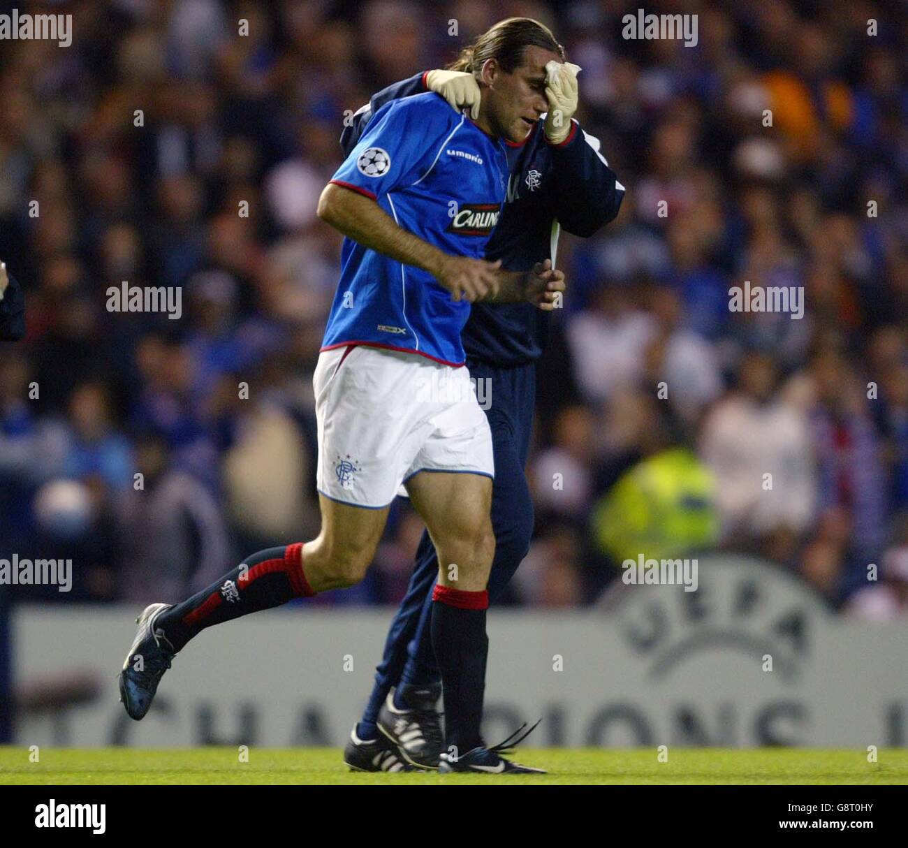 Rangers' Dado Prso is led off for treatment for a head wound during the ...
