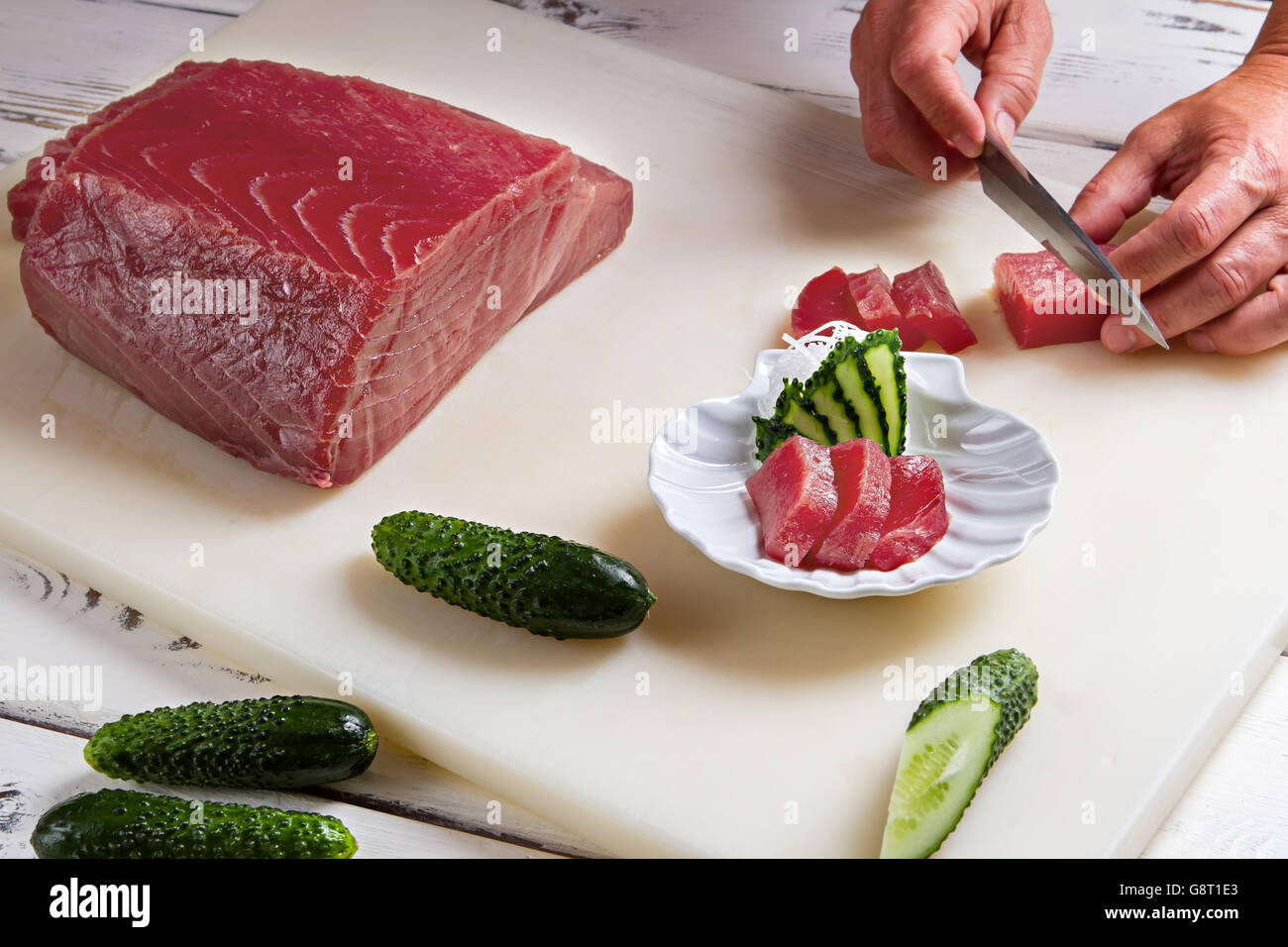 Hand with knife cuts fish Stock Photo - Alamy