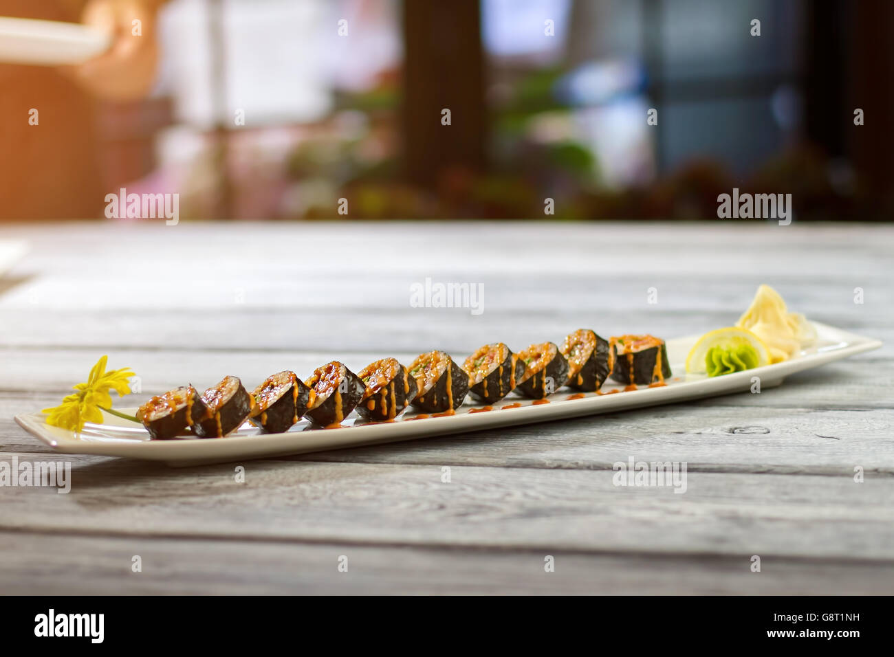 Long plate with sushi rolls Stock Photo - Alamy