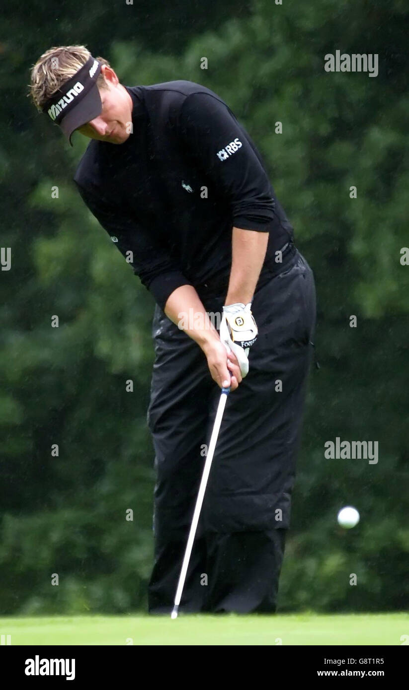 England's Luke Donald putts in the pouring rain during the first day of ...