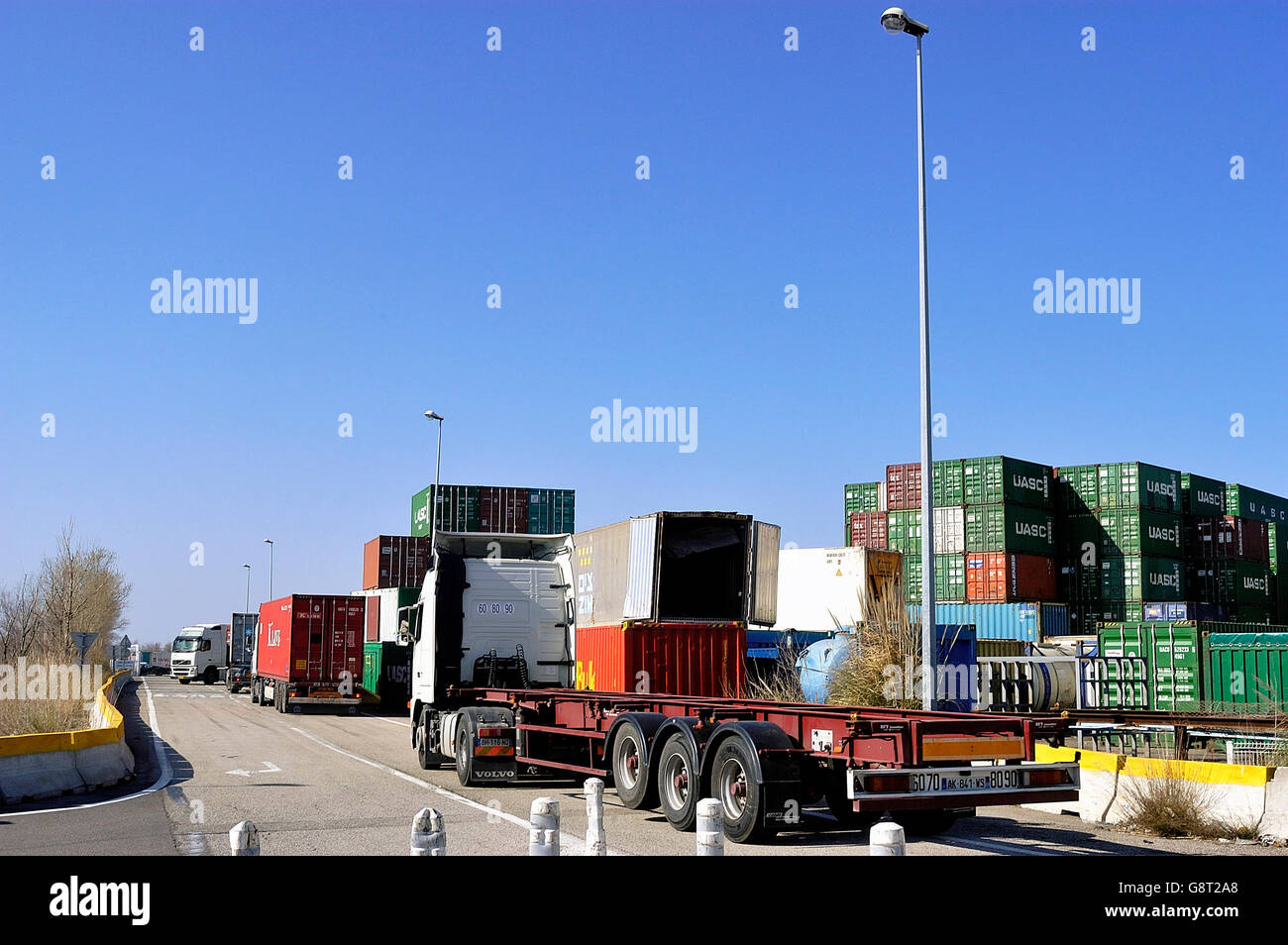 Trucks moving the containers to bring them to the quay of loading to be ...