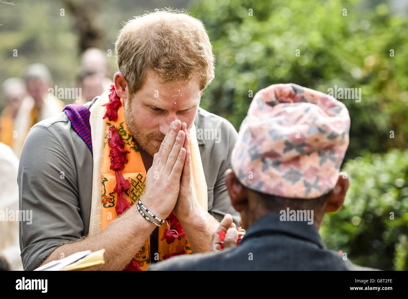 Prince Harry exchanges a namaste greeting with a villager at Bhir Kuna ...