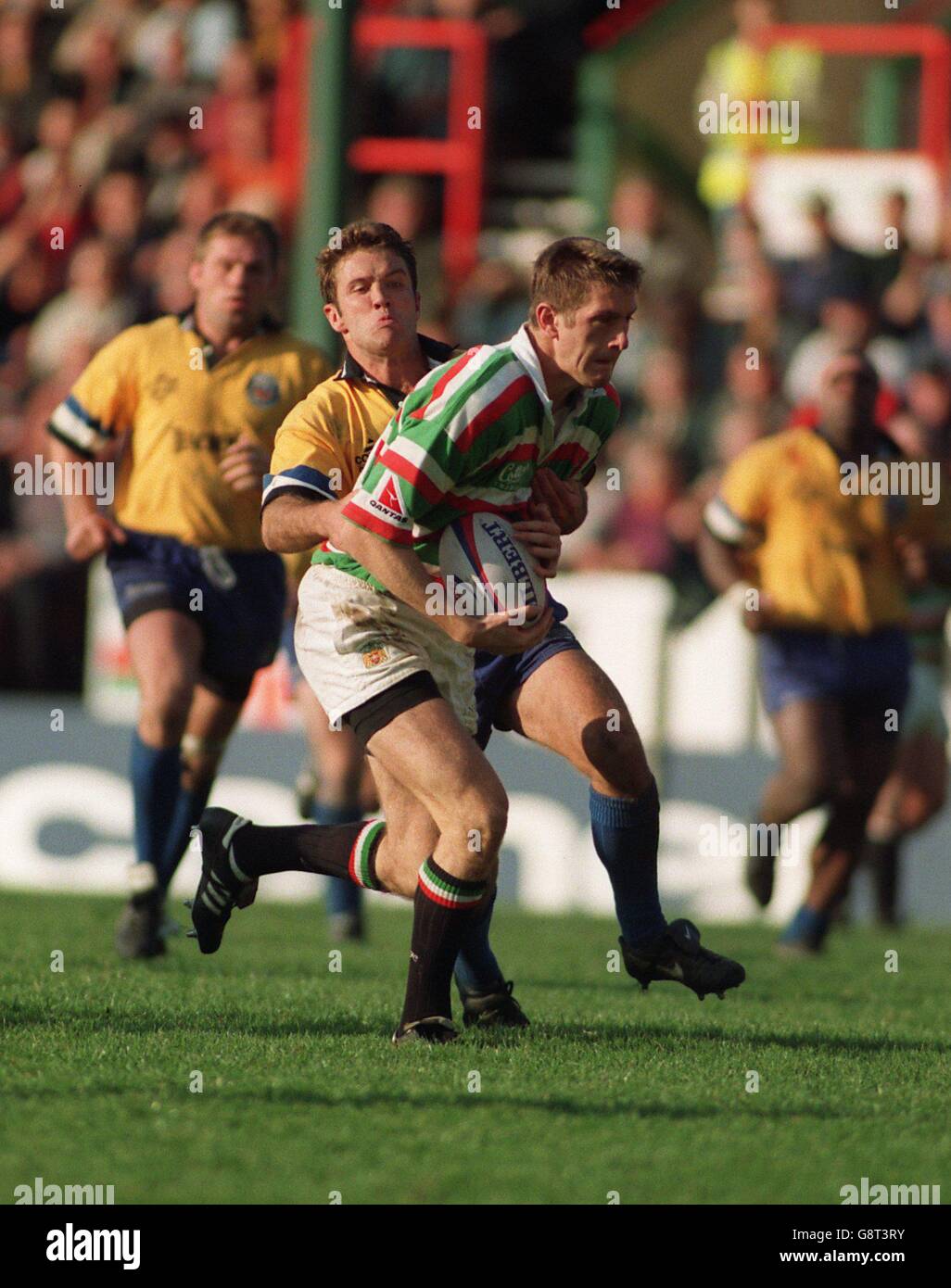 Bath's Phil De Glanville (left) tries to tackle Leicester's Will ...