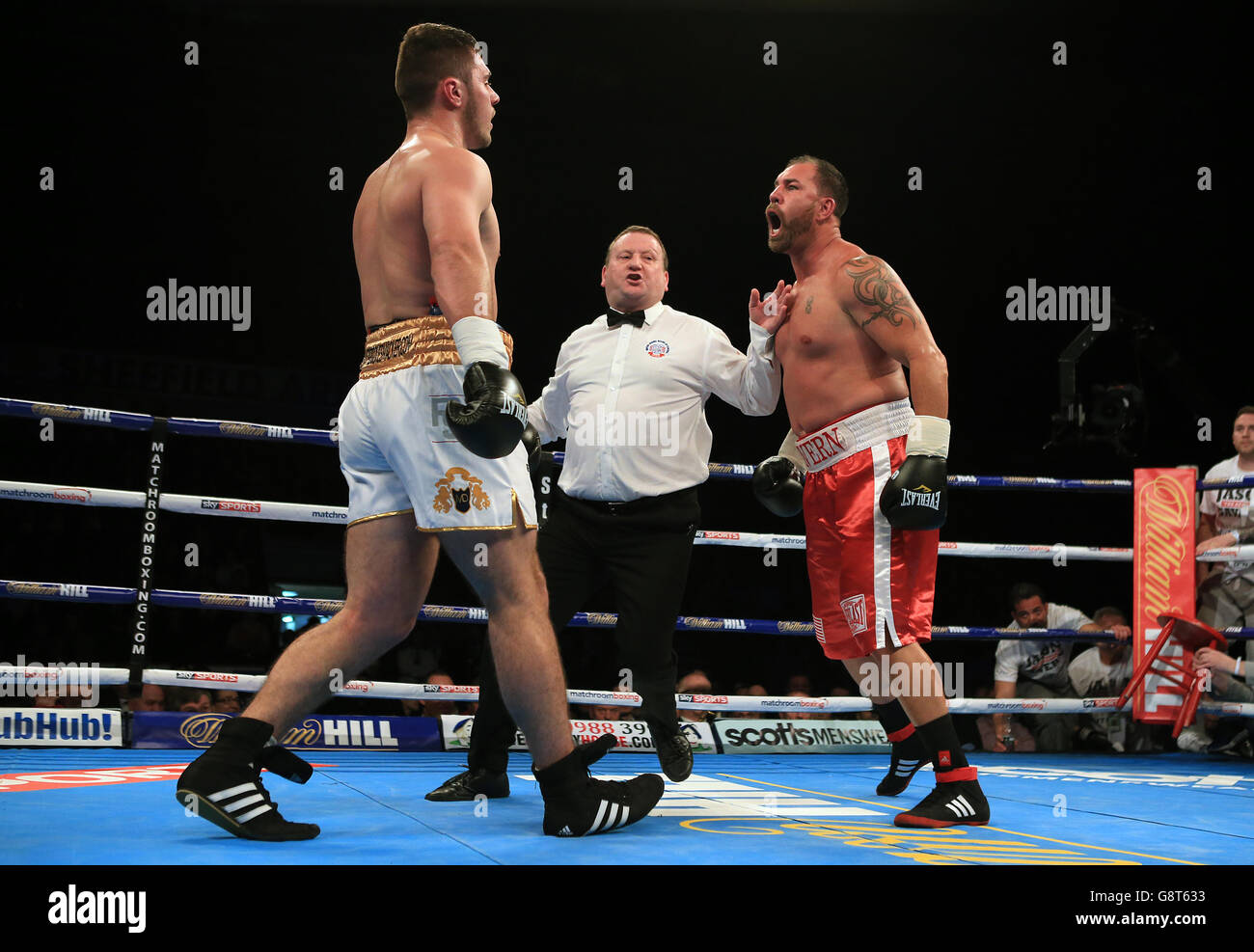 Jason Gavern shouts towards David Allen (left) as ref Howard Foster ...