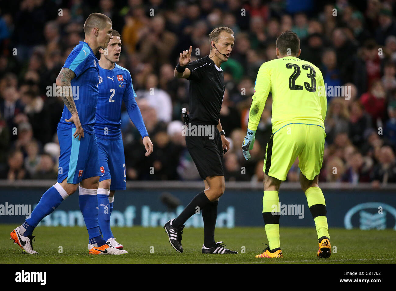 Slovakia goalkeeper Matus Kozacik (right) protests to referee Ola ...