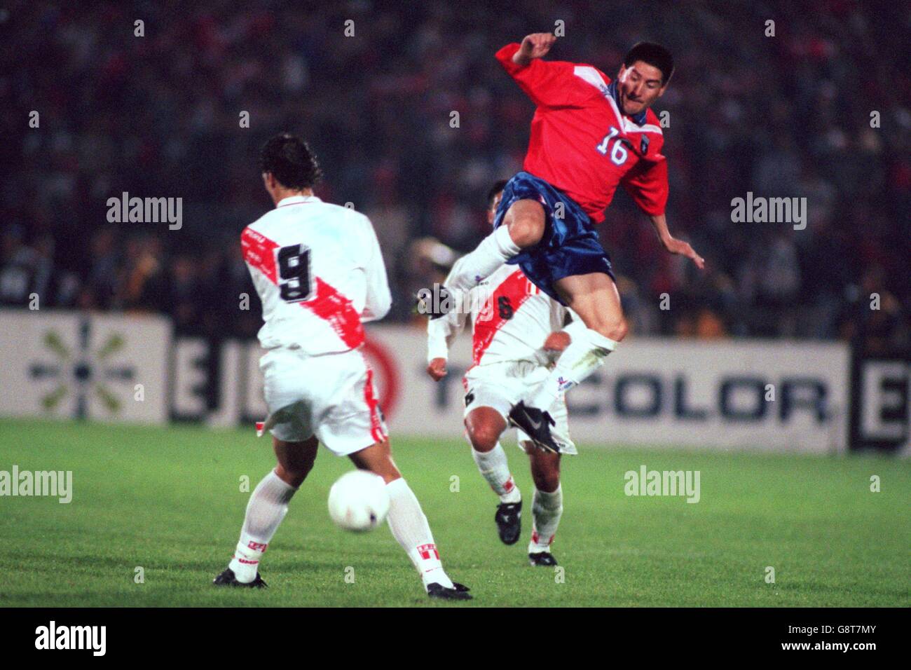 Flavio Maestri Andrade of Peru (left) braces himself as Chile's Fernand ...
