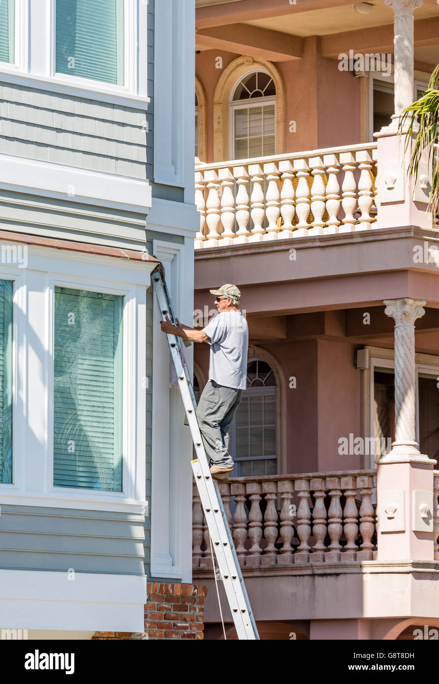 Old Painter Working on Ladder and coastal homes Stock Photo - Alamy