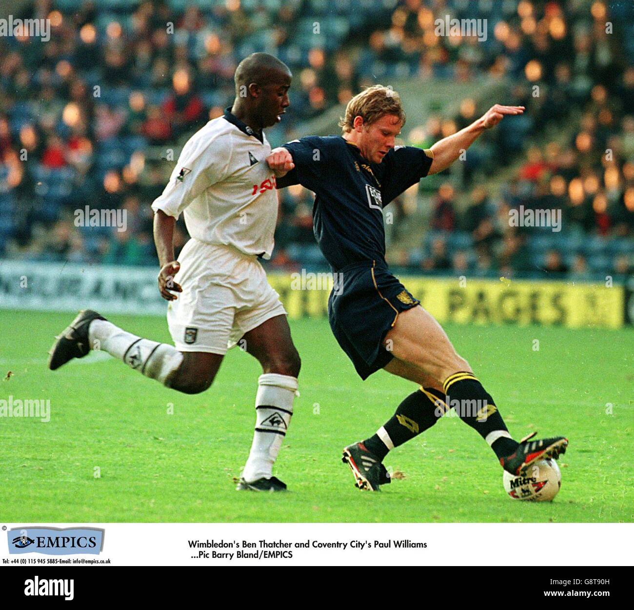 Wimbledon's Ben Thatcher (right) shields the ball from Coventry City's ...