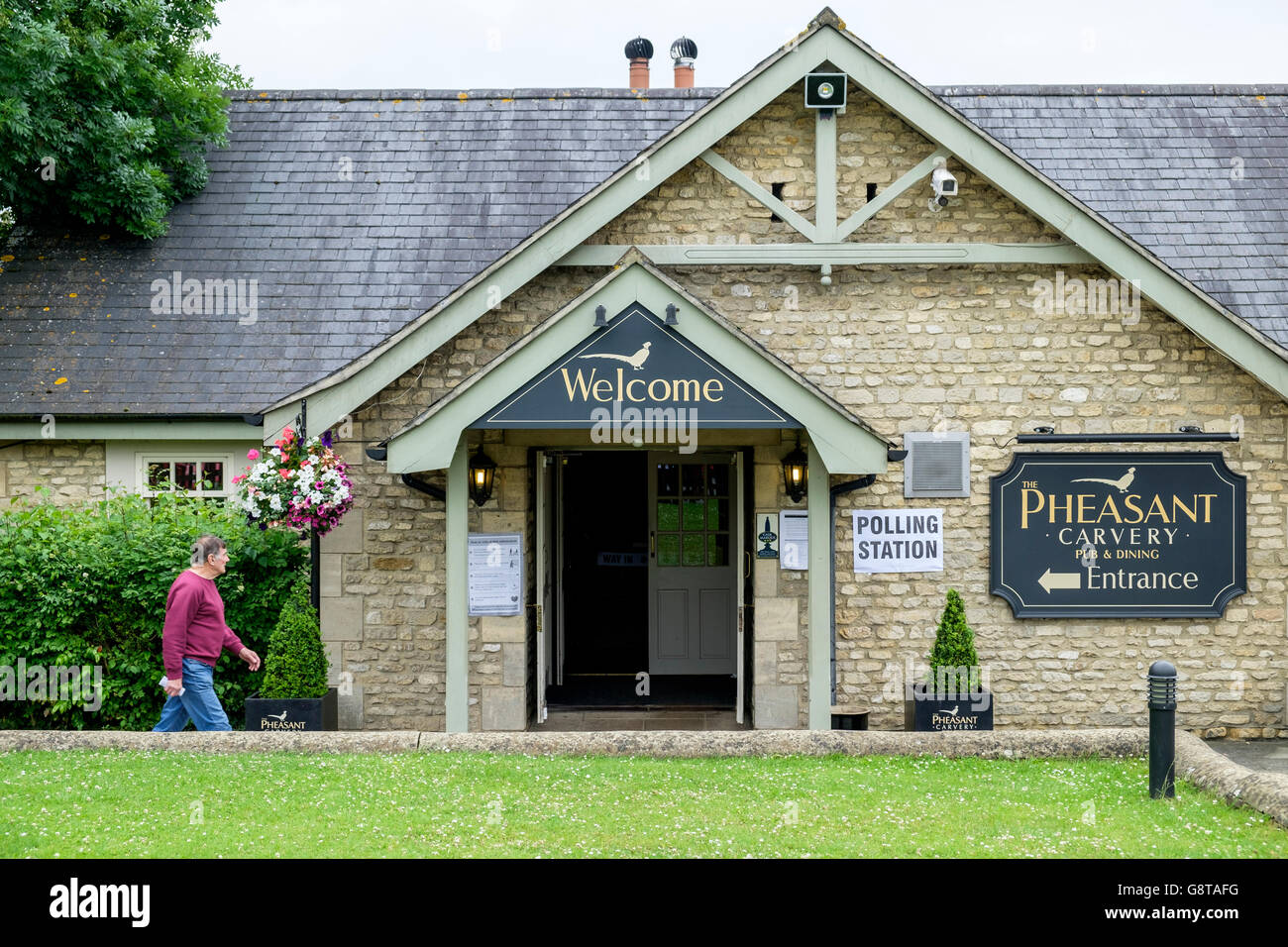 A voter is pictured entering a polling station situated inside a local ...