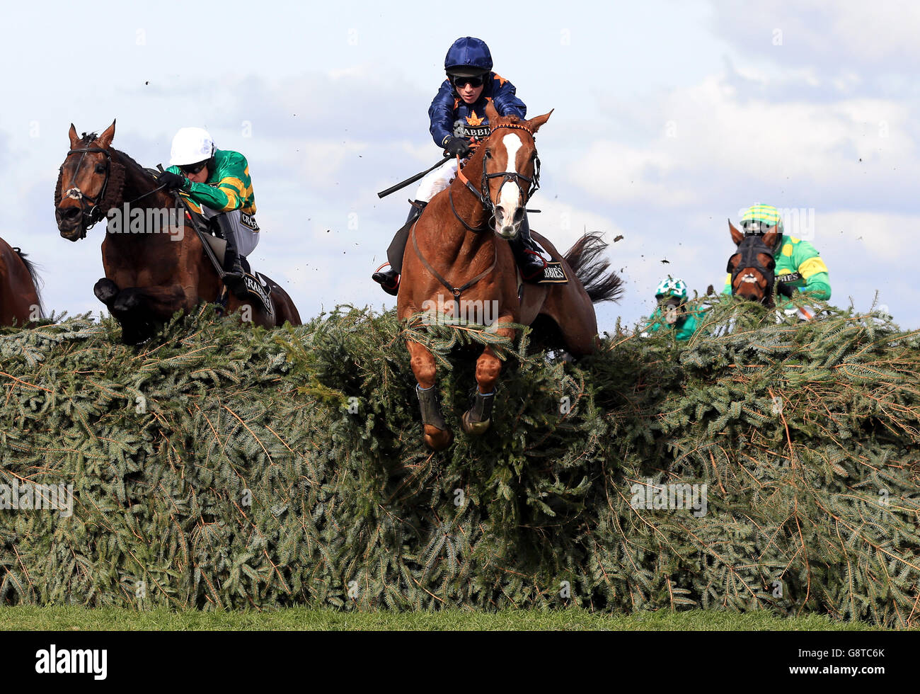 Fairy Rath ridden by jockey Tom Cannon clears a fence followed by ...