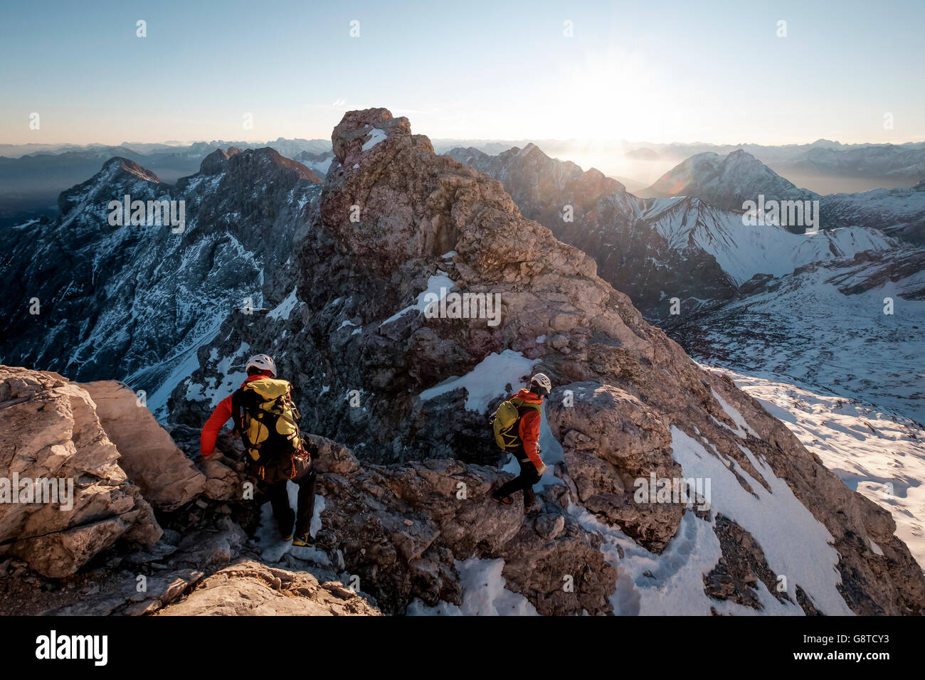 Two mountaineers climbing on mountain peak in European Alps Stock Photo ...