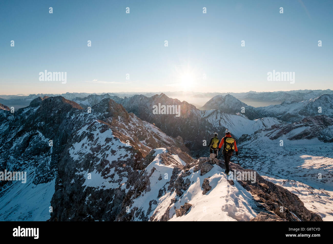 Two mountaineers climbing on mountain peak in European Alps Stock Photo ...