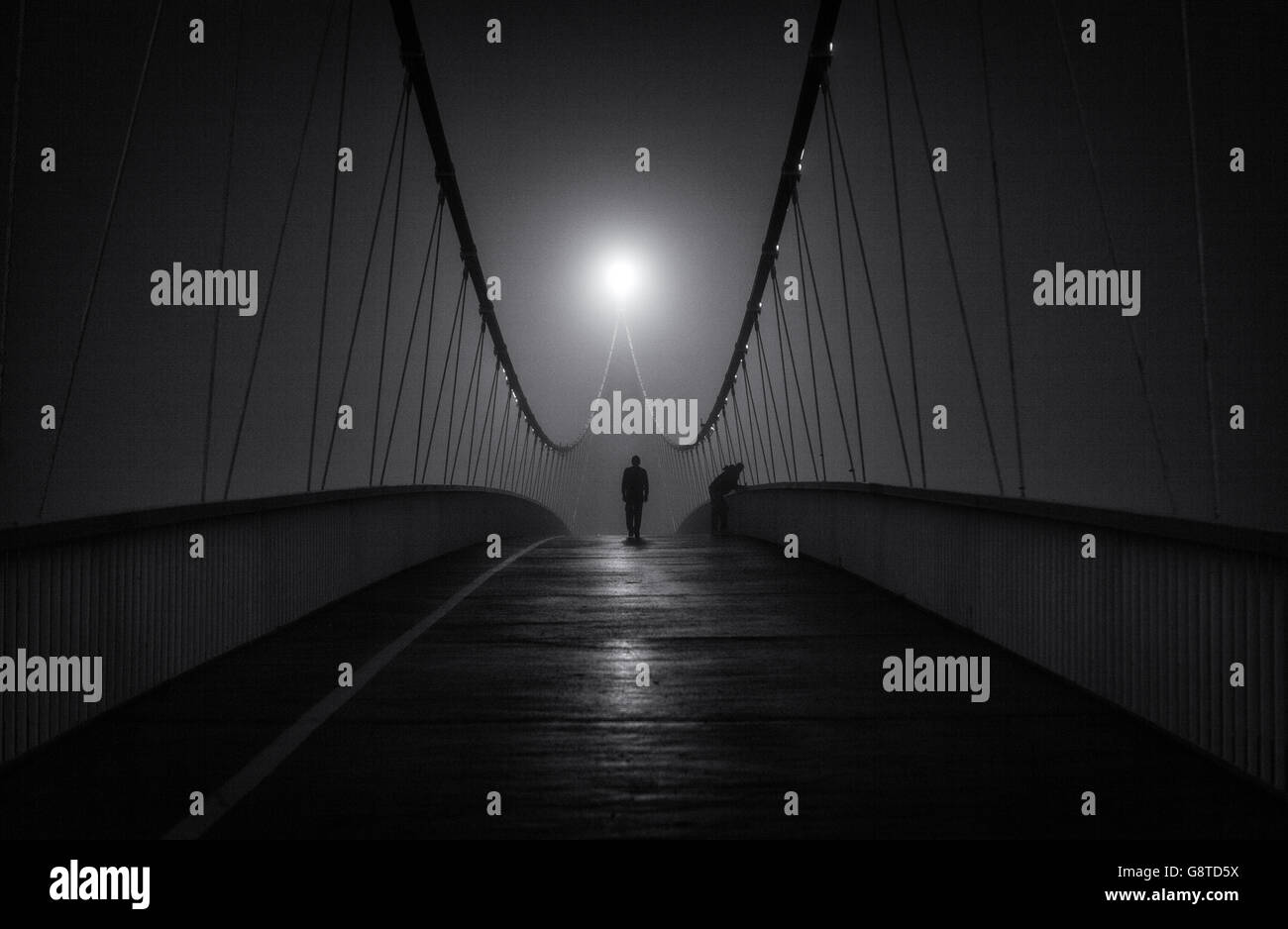 Couple walking over bridge in Osijek at night Stock Photo - Alamy
