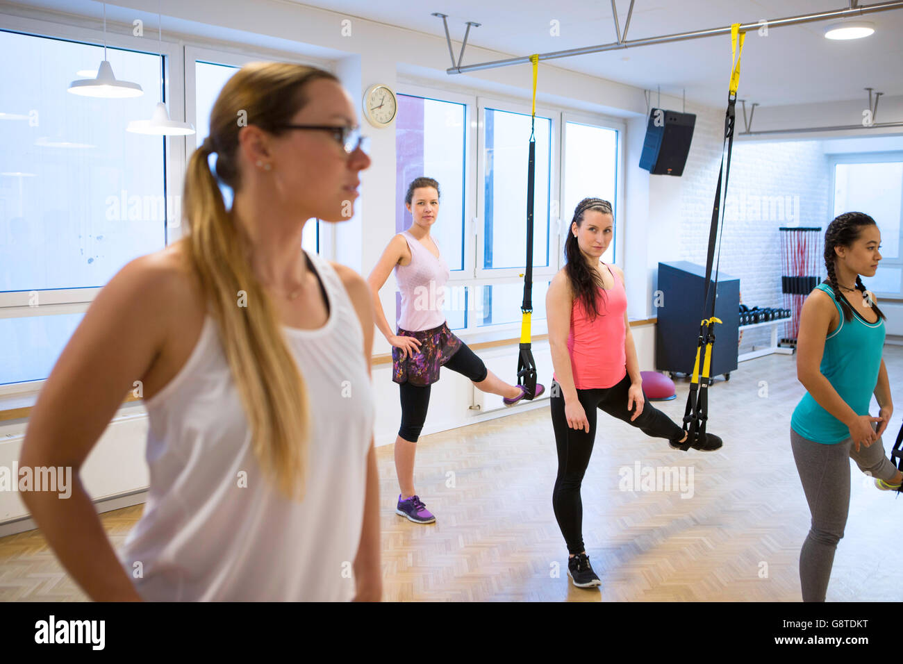Women in exercise class doing suspension training Stock Photo - Alamy