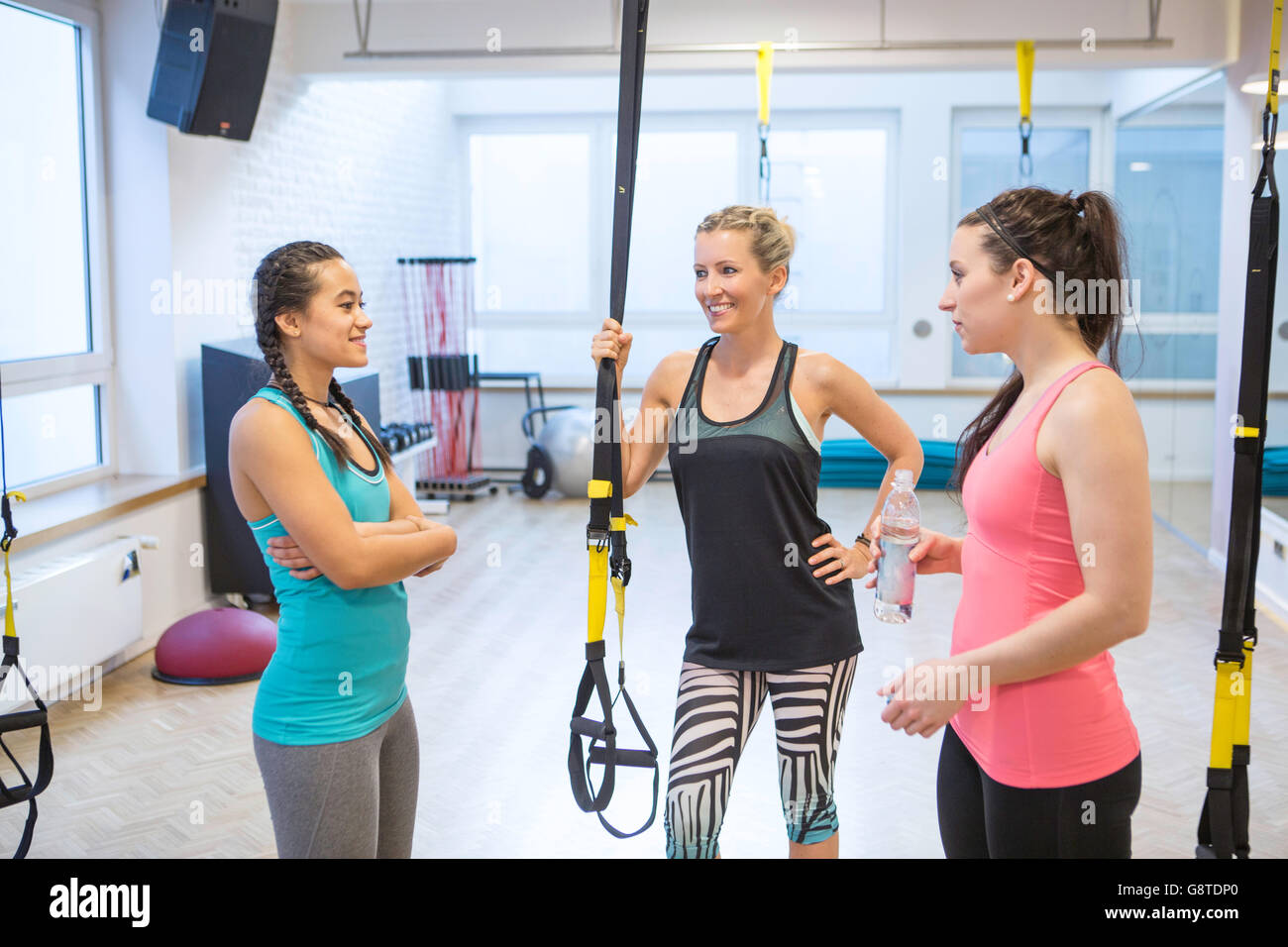 Fitness instructor in exercise class talking to women Stock Photo - Alamy