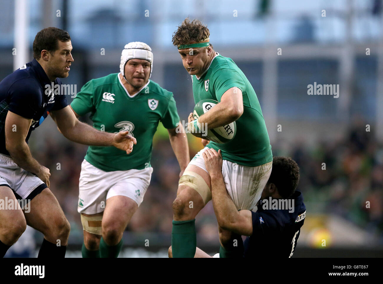 Ireland's Jamie Heaslip (centre) is tackled by Scotland's Alex Dunbar ...