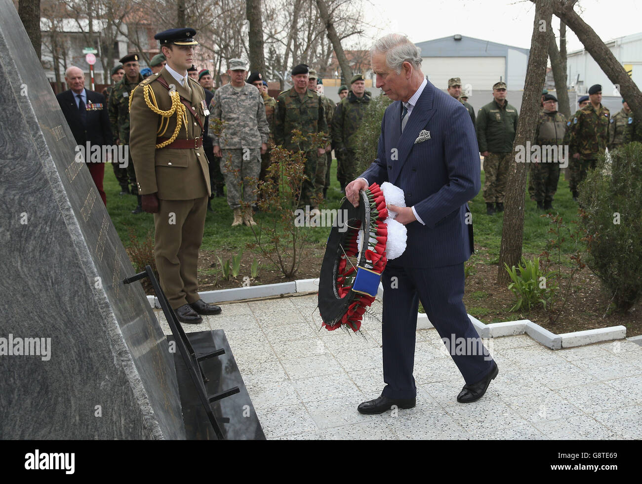 The Prince of Wales lays a wreath at a memorial to international ...