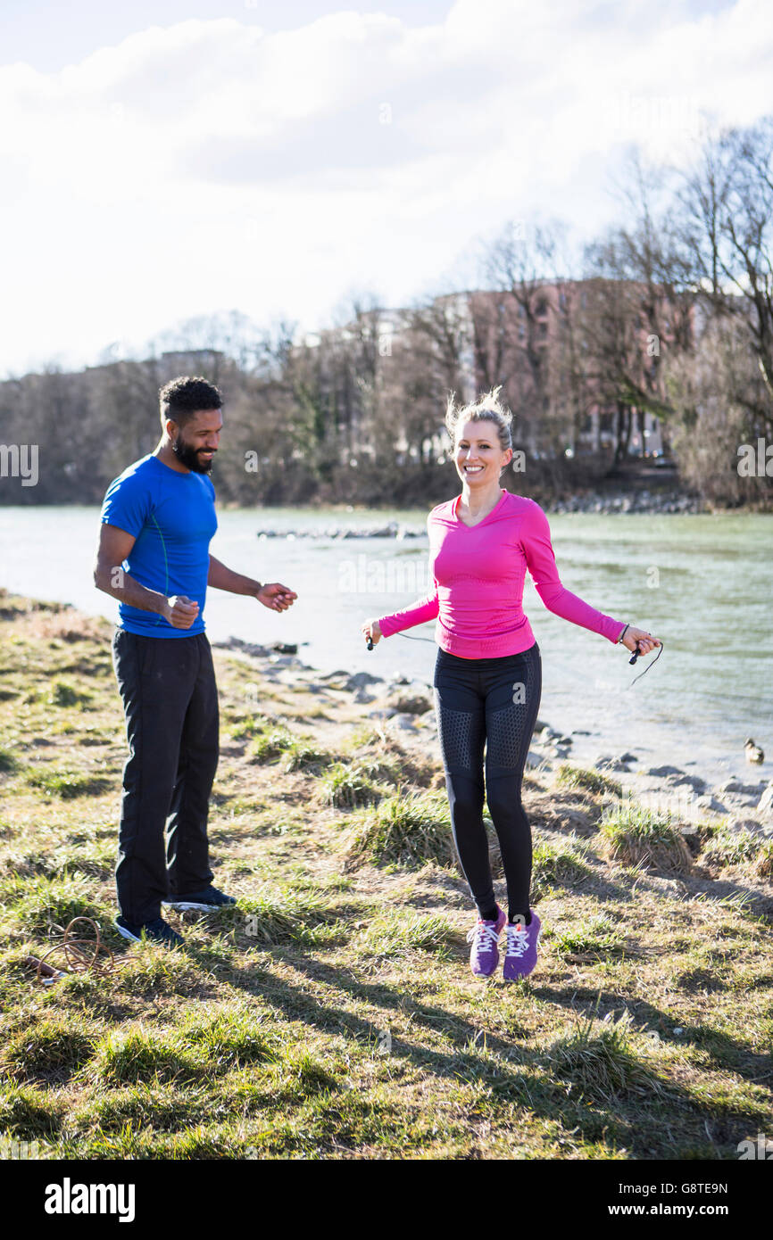 Young couple skipping by the riverside Stock Photo - Alamy