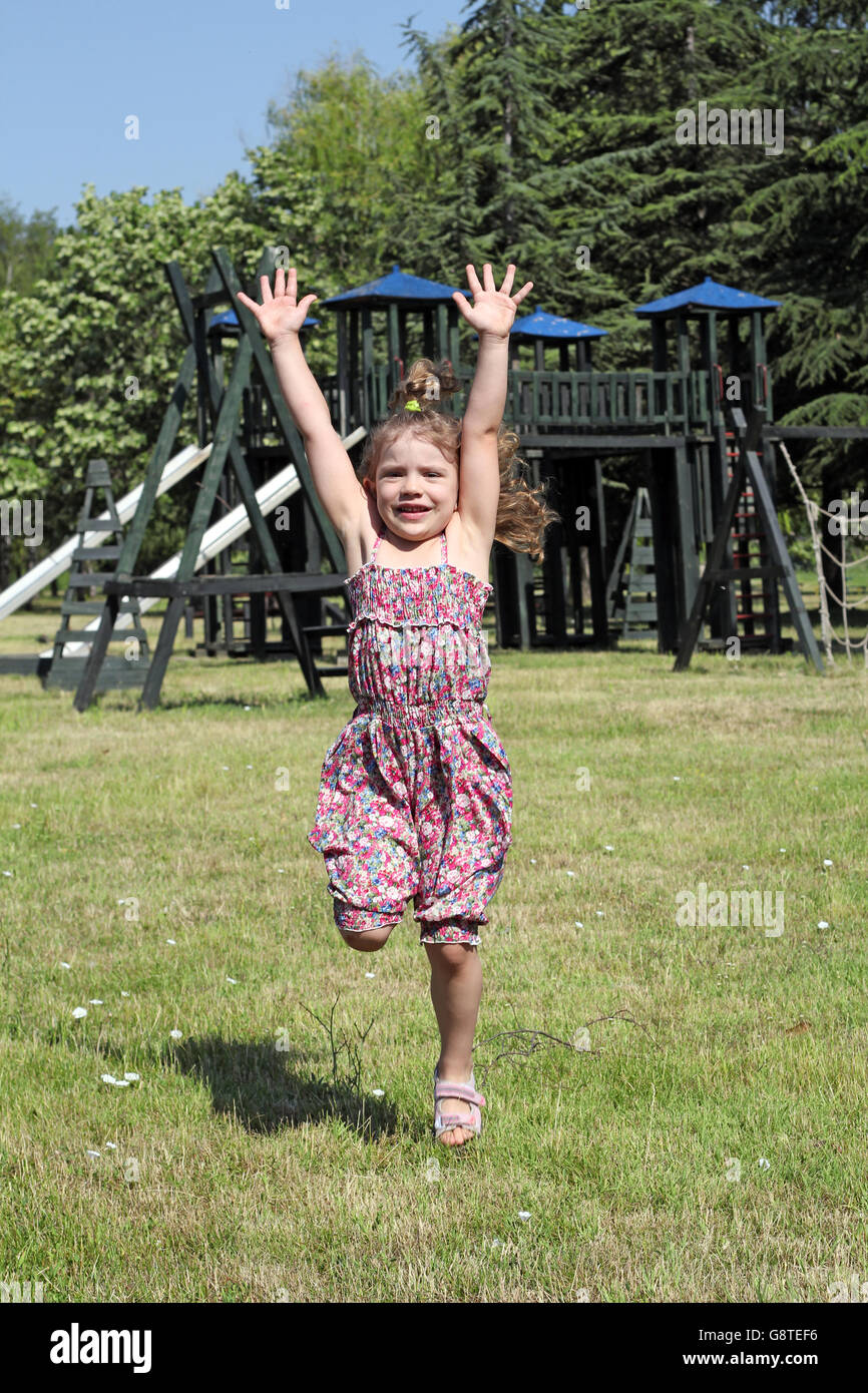 little girl jumping on playground Stock Photo - Alamy