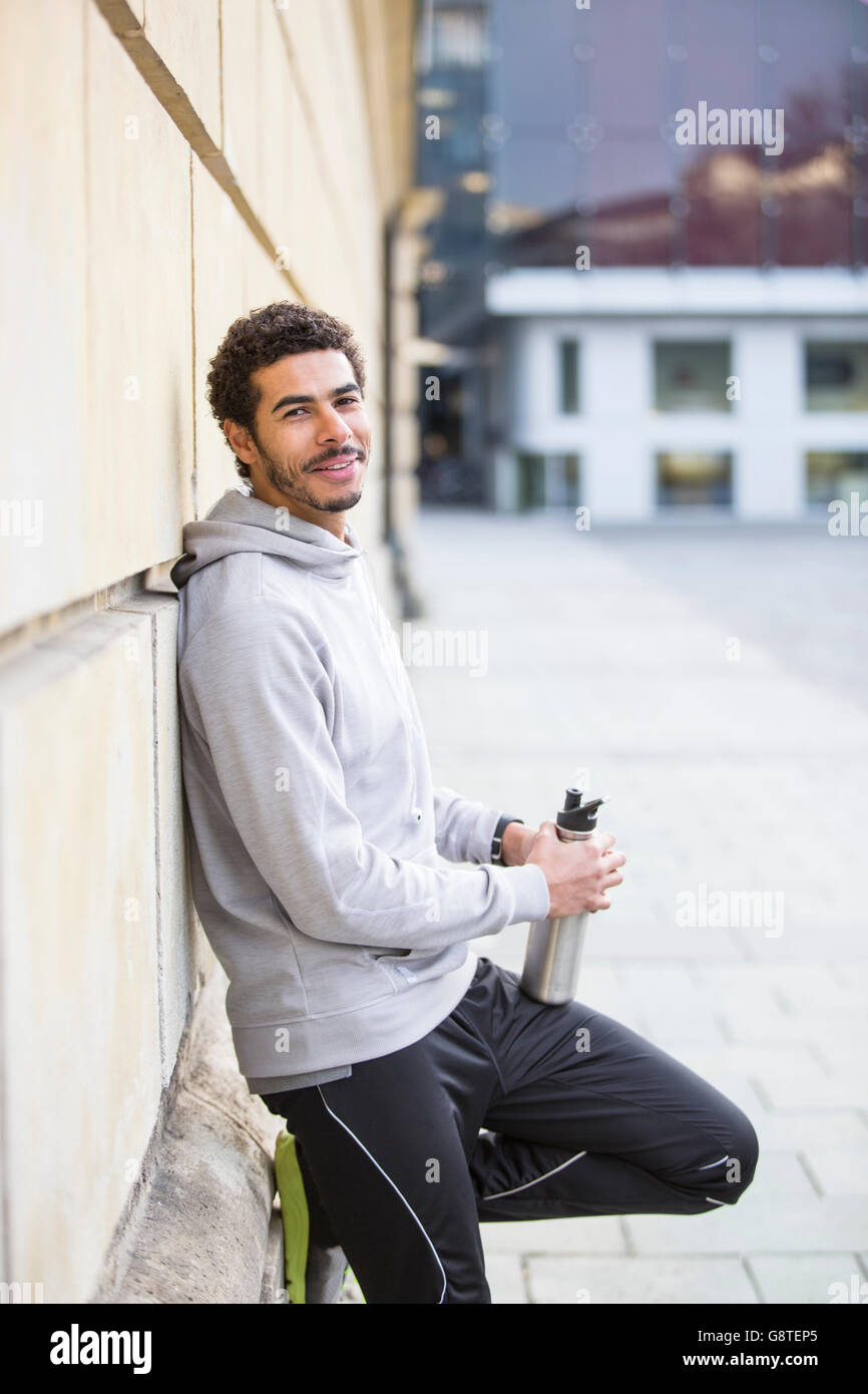 Mid adult man leaning against wall hi-res stock photography and images ...