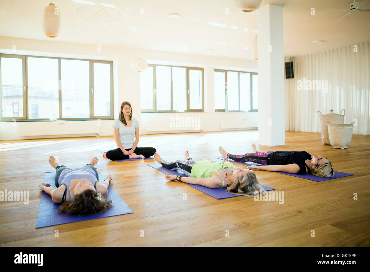 Women practicing yoga in class Stock Photo - Alamy