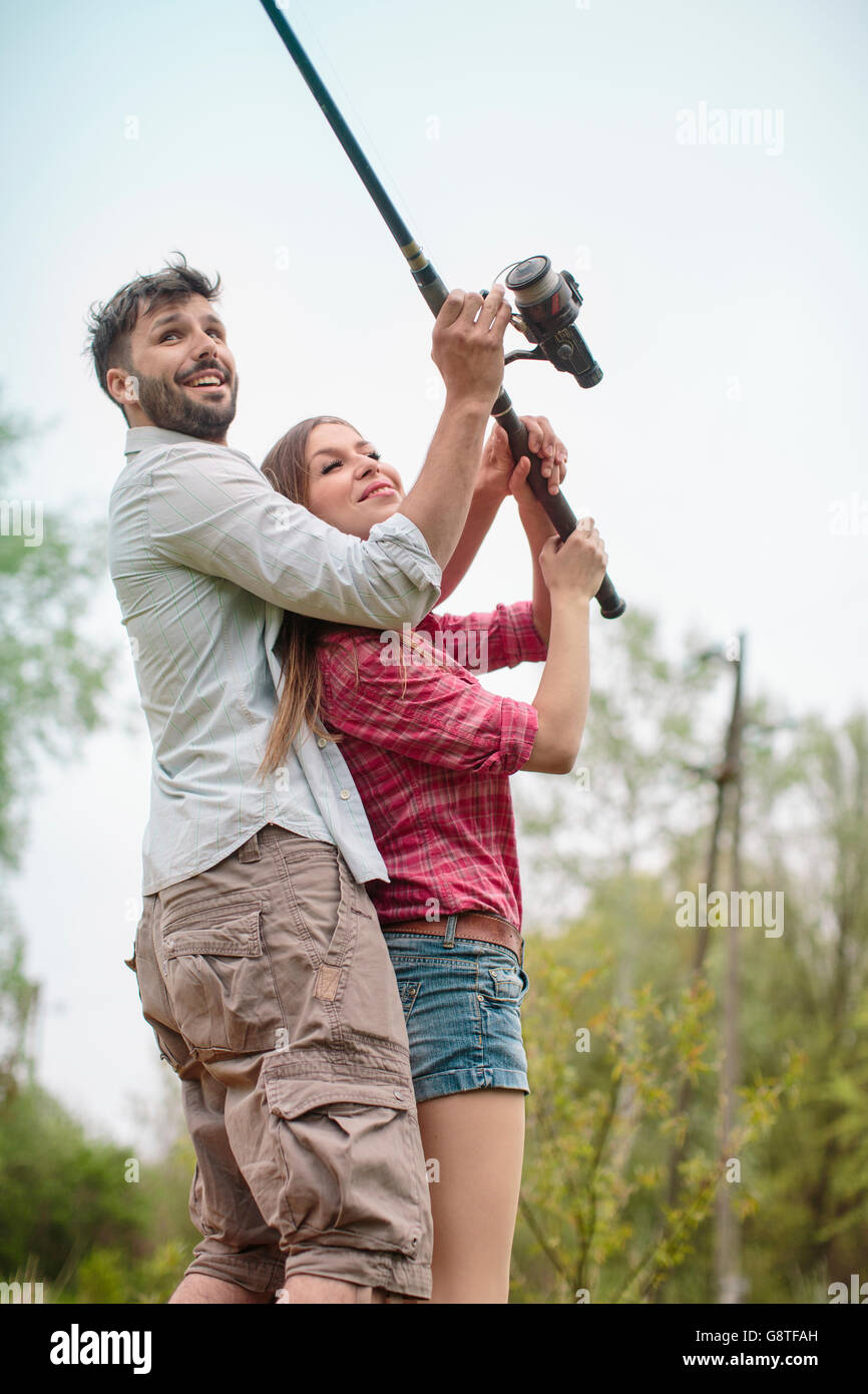 Young couple fishing in lake together Stock Photo - Alamy