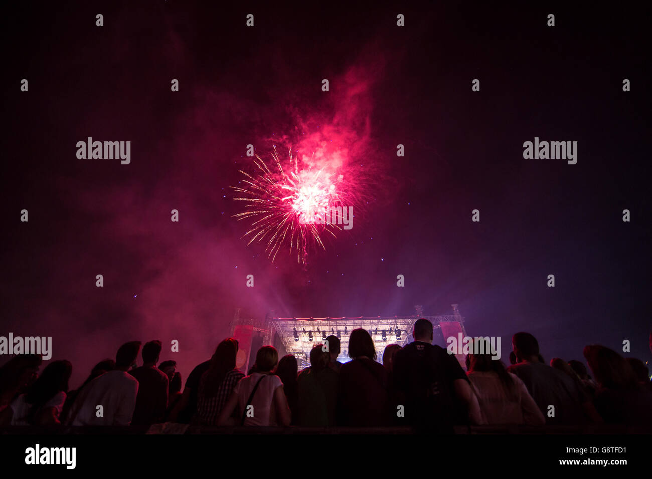 Firework display over buildings in city at night Stock Photo - Alamy